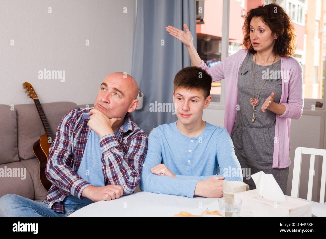 Woman scolding son and husband Stock Photo - Alamy