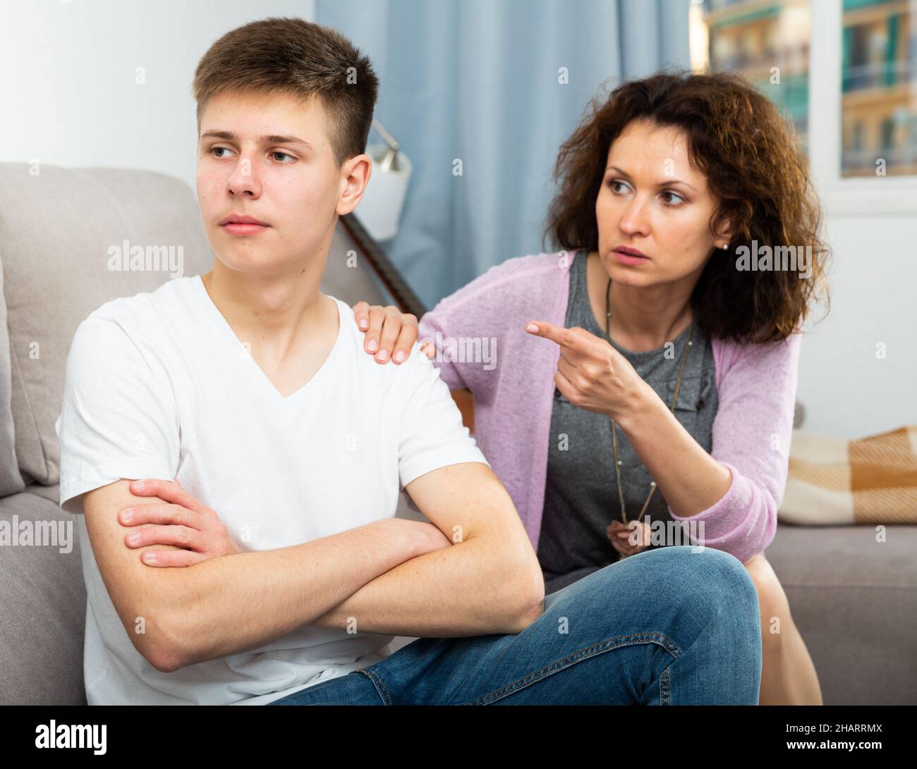 Mother scolding troubled teen boy Stock Photo - Alamy