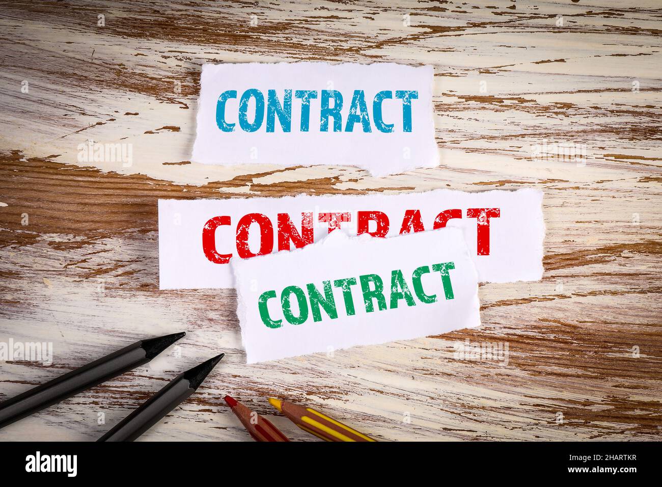 Contract. Pencils and sheets of paper with text on a wooden background ...