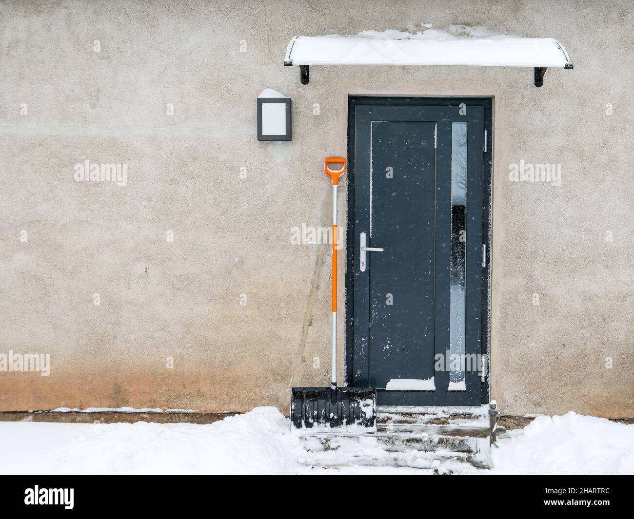 House wooden entrance door. Snow and ice. Exterior of the building ...