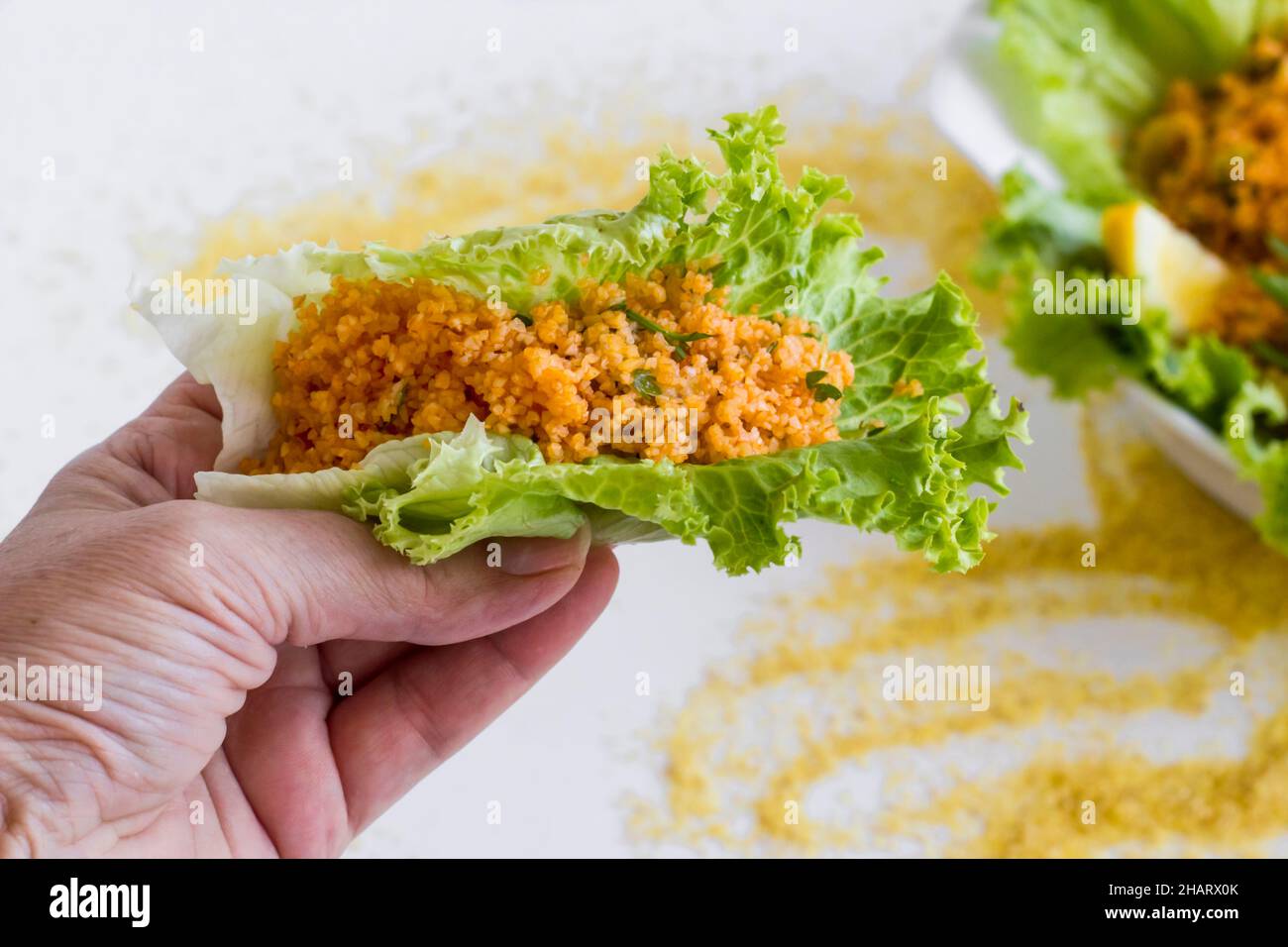 Hand holding Traditional Turkish Wheat ,Kisir Bulgur Salad in lettuce ...