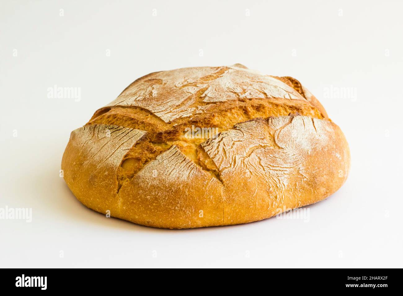 Rustic, whole-wheat round homemade whole bread on white with copy space ...