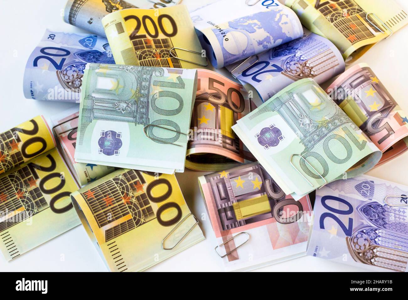 Fifty, hundred and two hundred euro banknotes clipped,folded and heap ...
