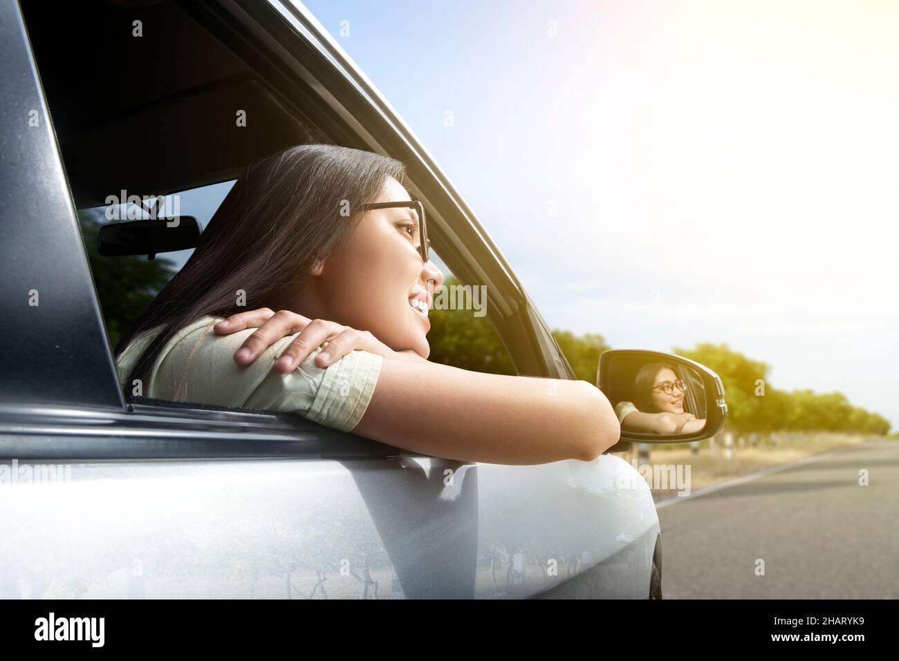 Asian woman with sunglasses leaning on window car Stock Photo - Alamy