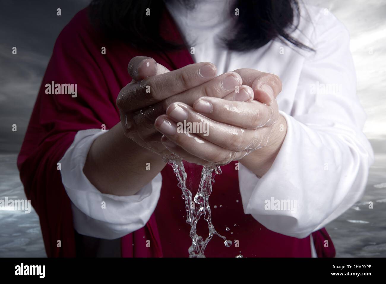 Jesus Christ with open palm giving hold the water with dramatic ...