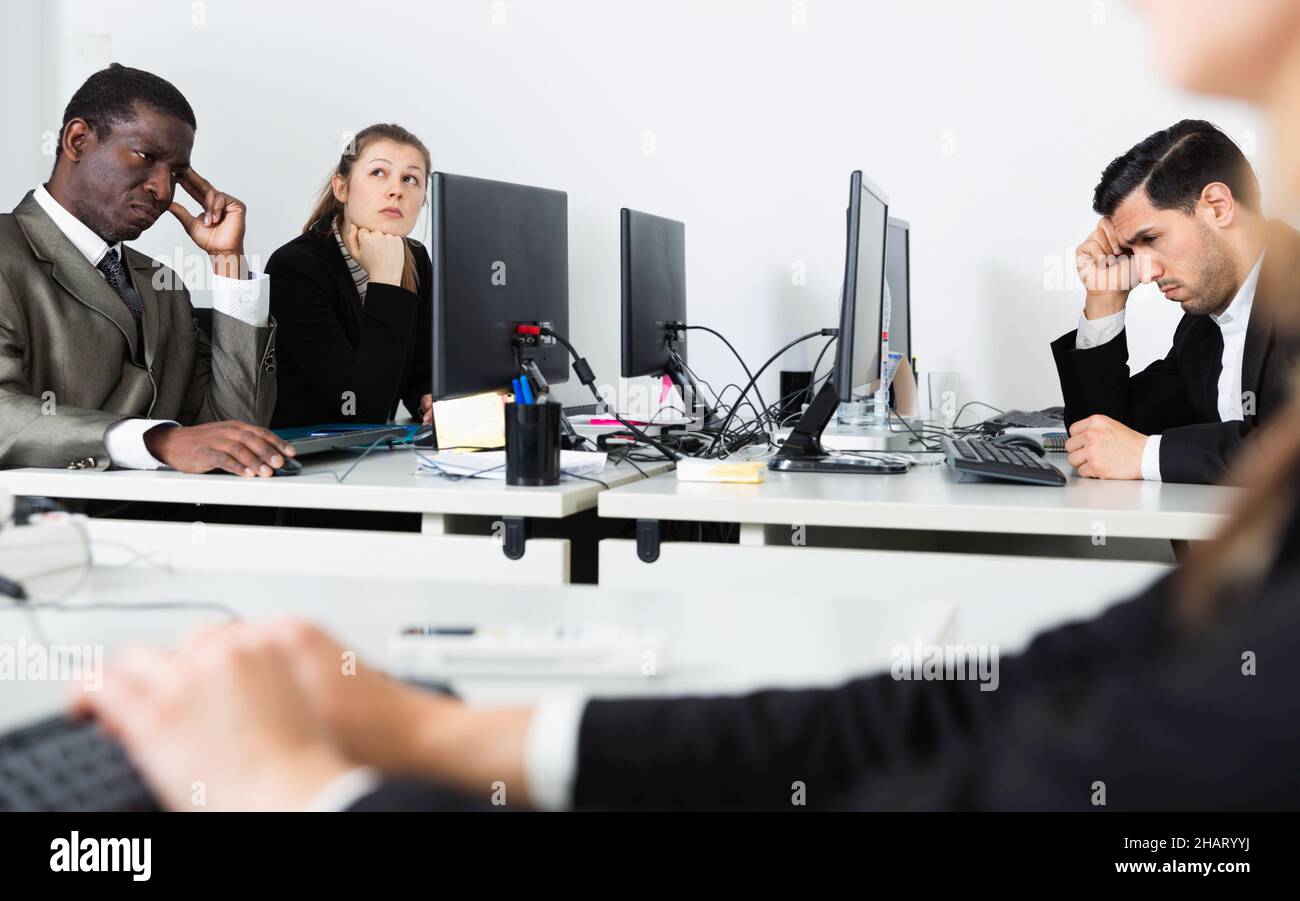 Successful coworkers engaged in business activities in busy open plan ...