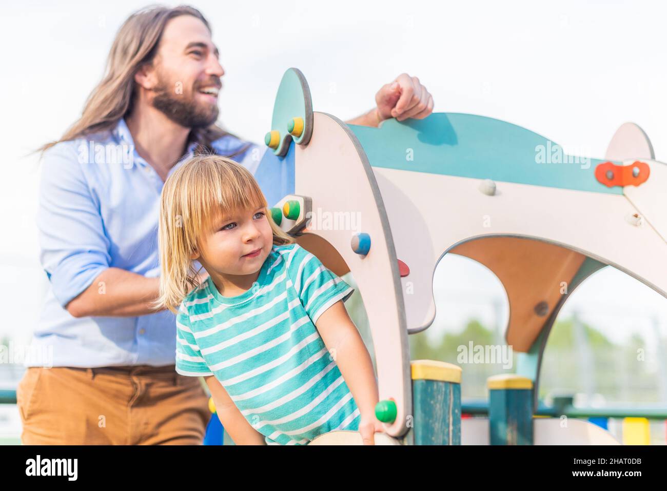 A boy playing on the playground with his young father Stock Photo - Alamy
