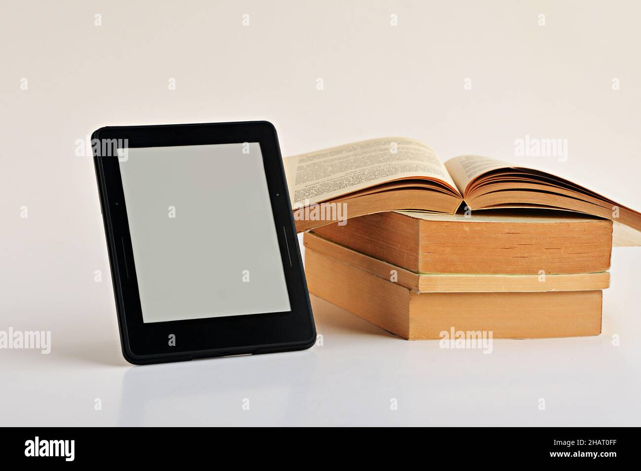 Digital e-book reader with a blank screen on the white ground with old ...