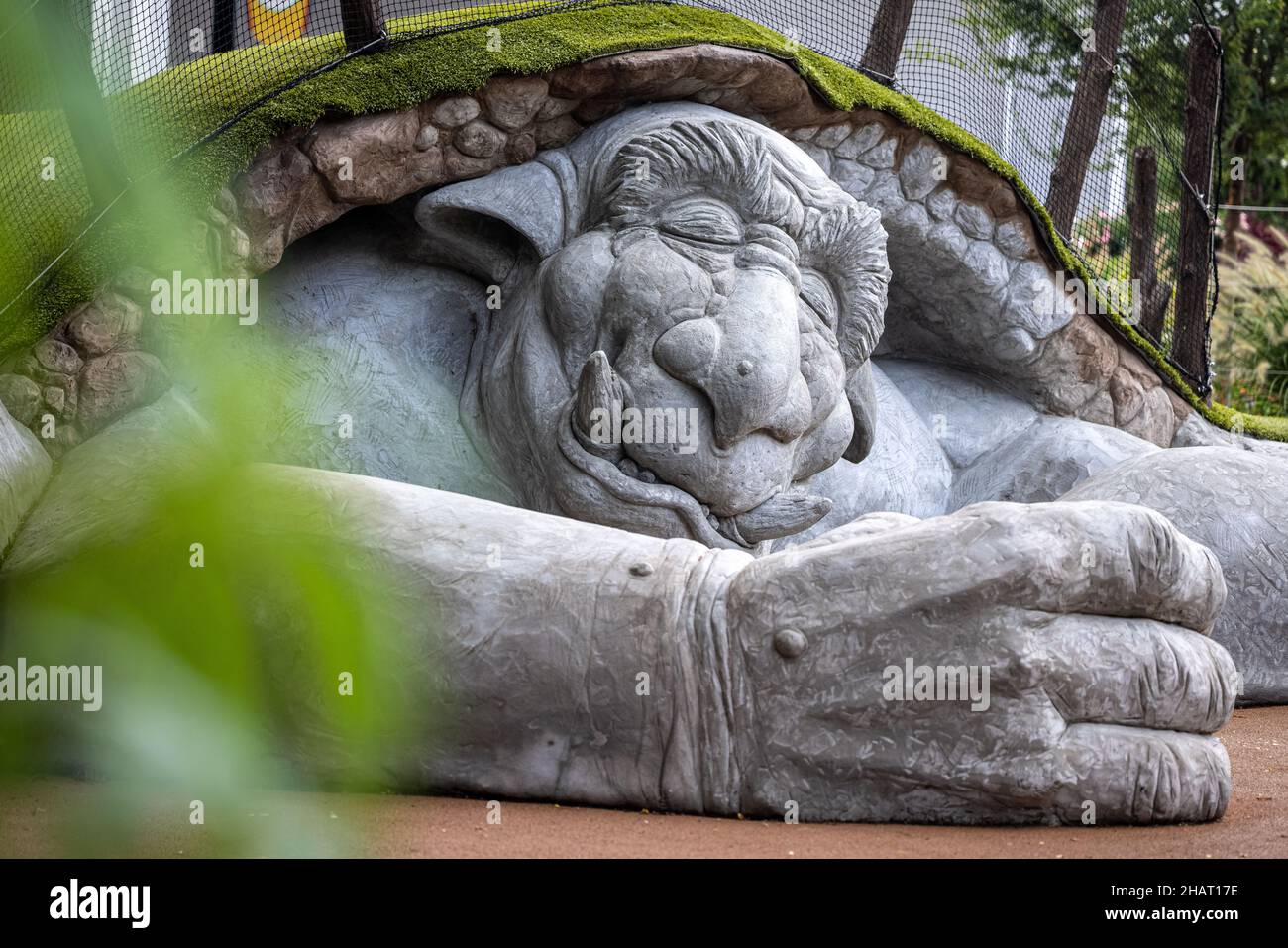 Closeup shot of a sleeping beast statue in a garden Stock Photo - Alamy