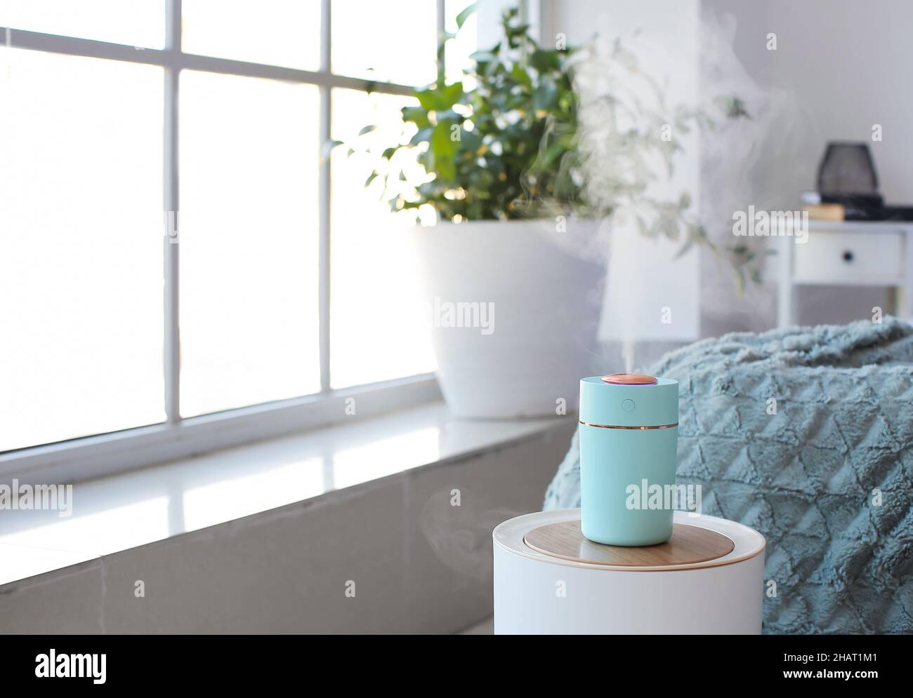 Modern humidifier on table in bedroom Stock Photo - Alamy