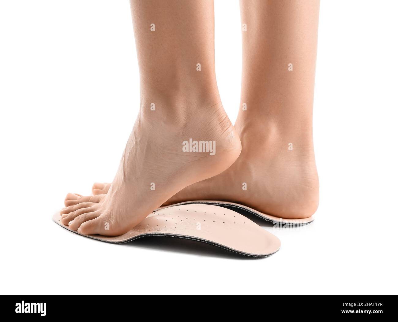 Female feet and orthopedic insoles on white background Stock Photo - Alamy