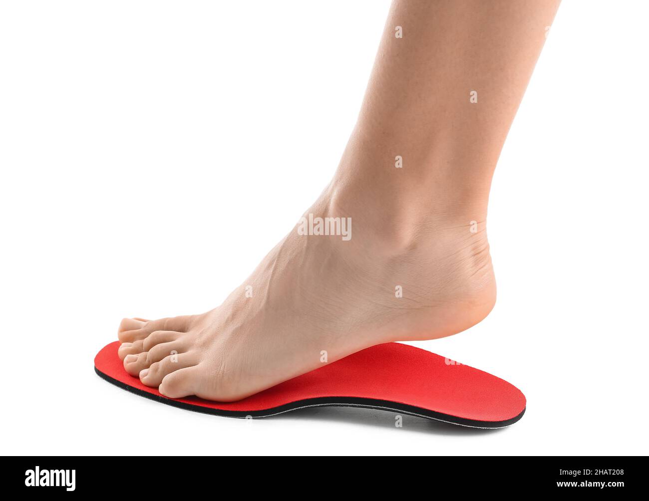Female foot and red orthopedic insole on white background Stock Photo ...