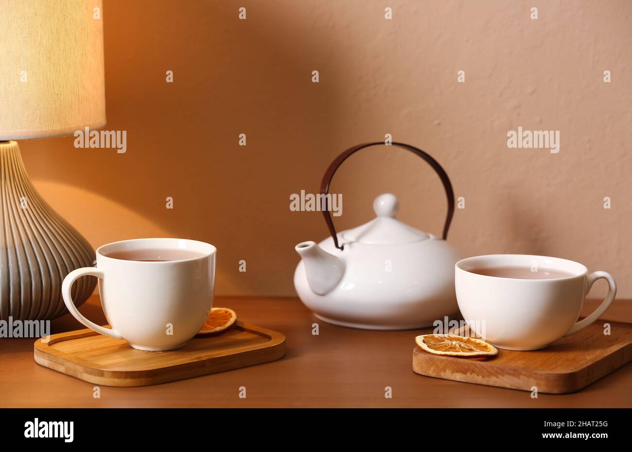 Cups of tasty tea and pot on table in cafe Stock Photo - Alamy