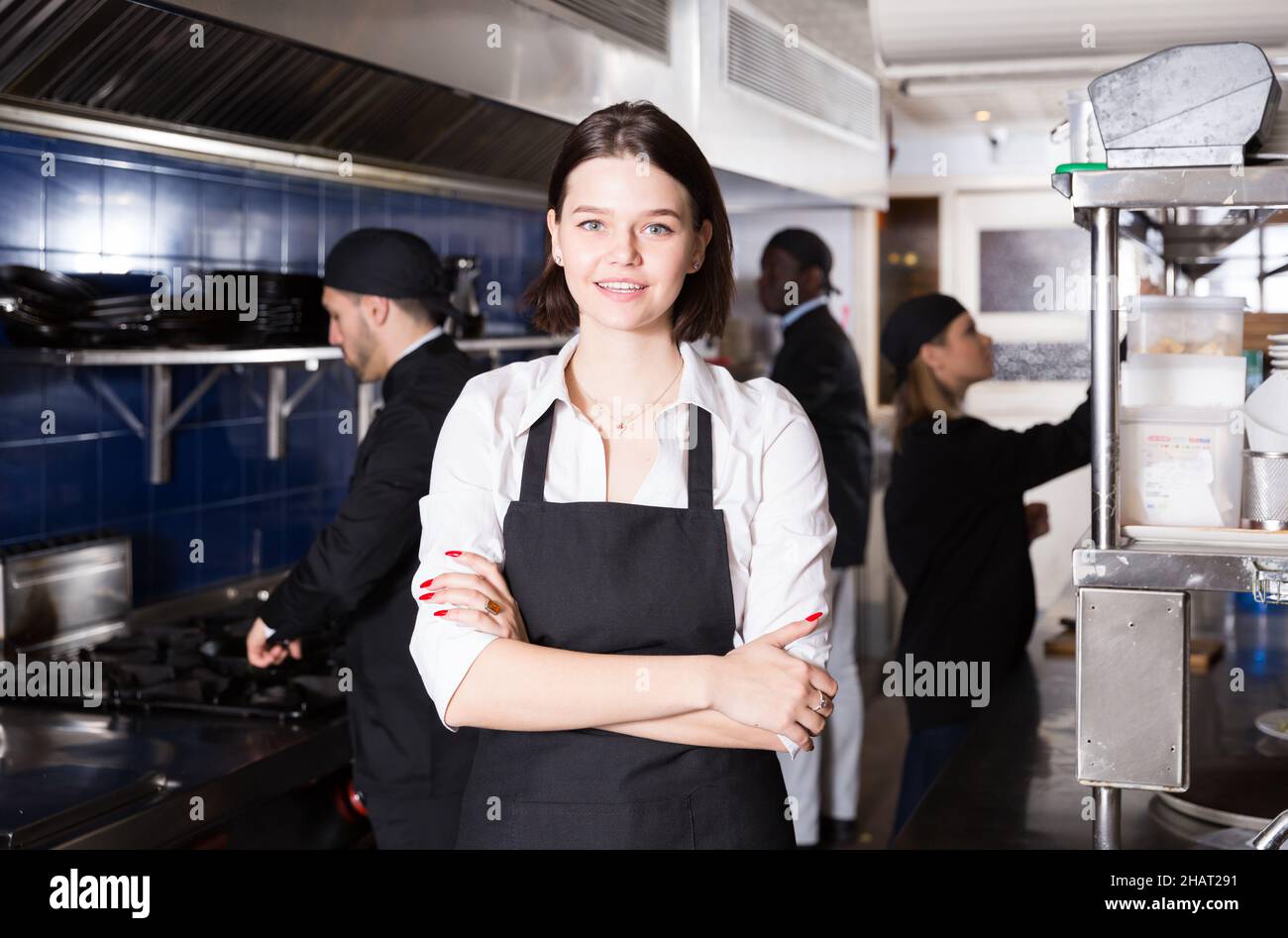 Waitress in restaurant kitchen Stock Photo - Alamy