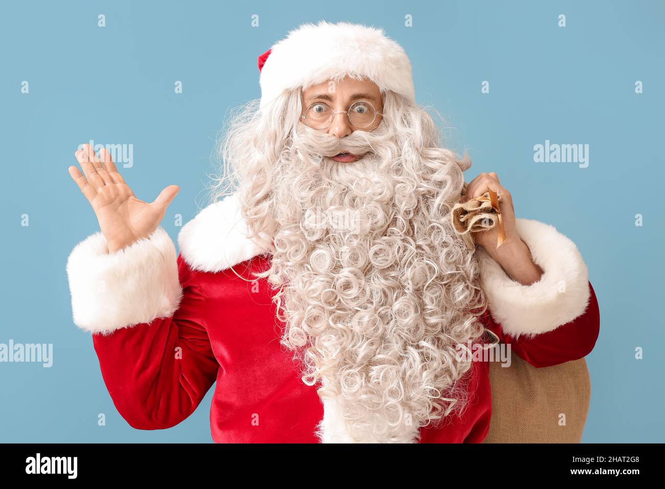 Shocked Santa Claus with sack bag on blue background Stock Photo - Alamy