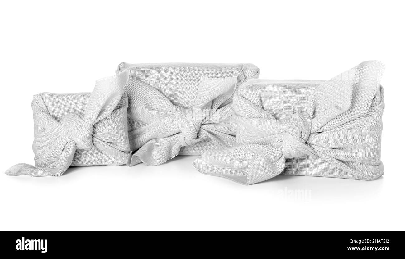 Gift boxes wrapped in fabric isolated on white background Stock Photo ...