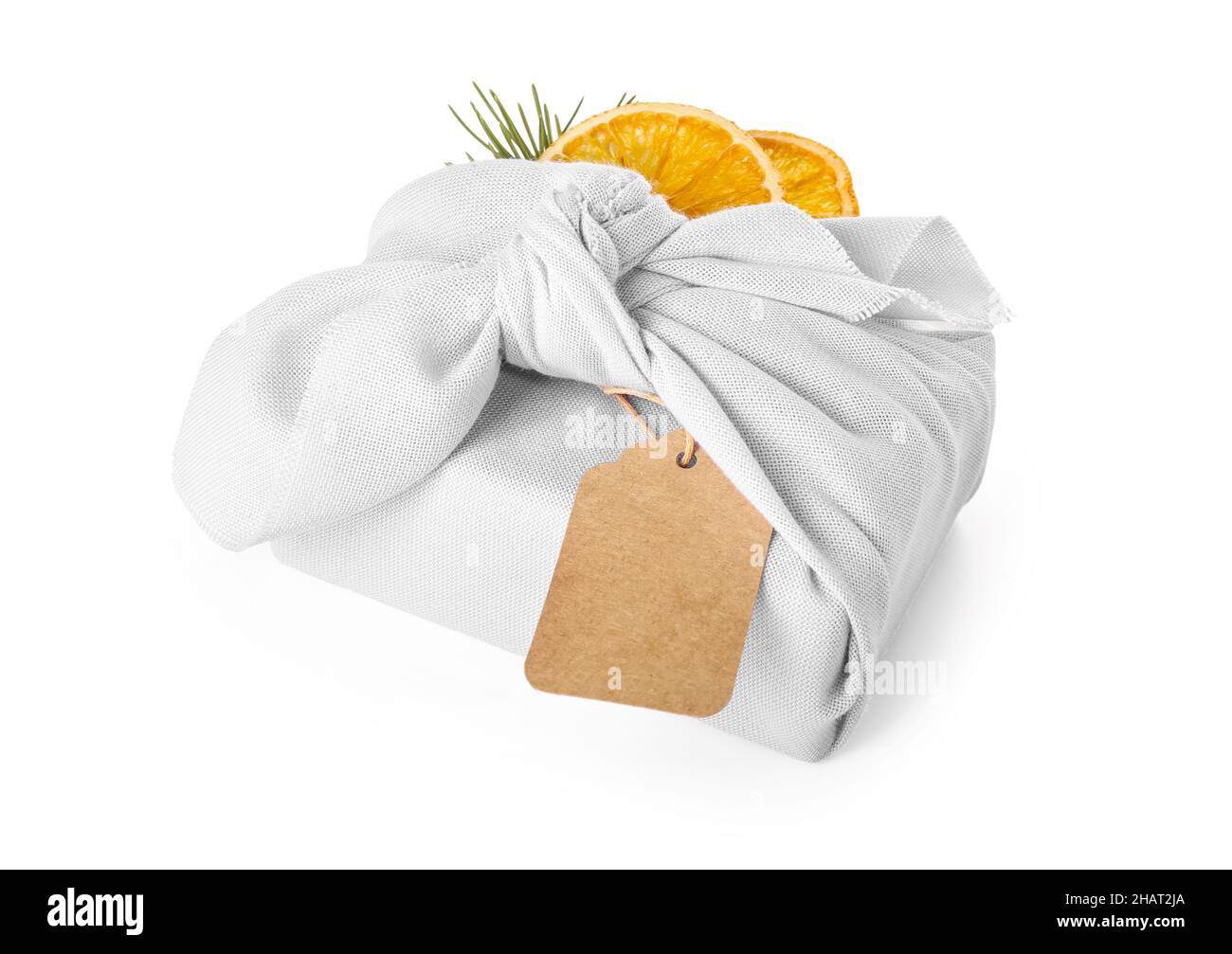 Christmas gift wrapped in cloth with tag on white background Stock ...