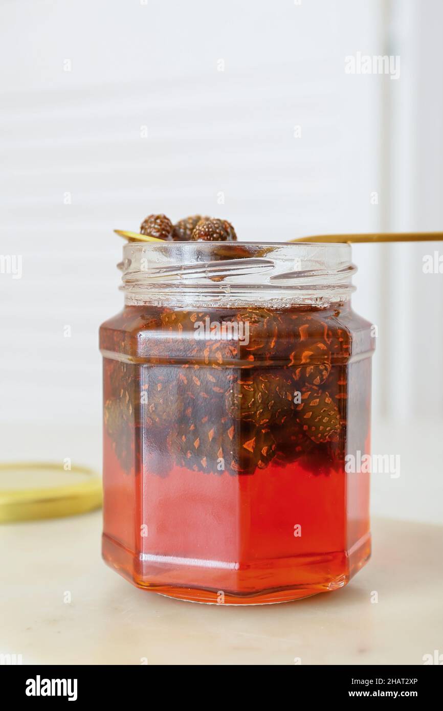 Jar of tasty pine cone jam on light table, closeup Stock Photo - Alamy