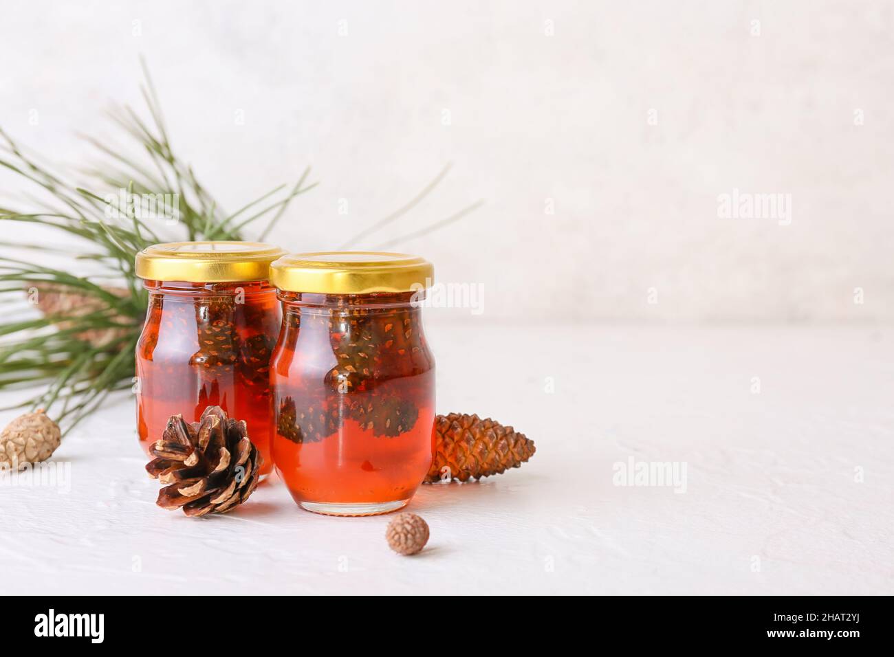 Jars of tasty pine cone jam on light background Stock Photo - Alamy