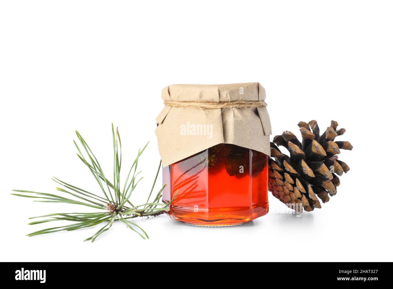 Jar of tasty pine cone jam and fir tree branch on white background ...