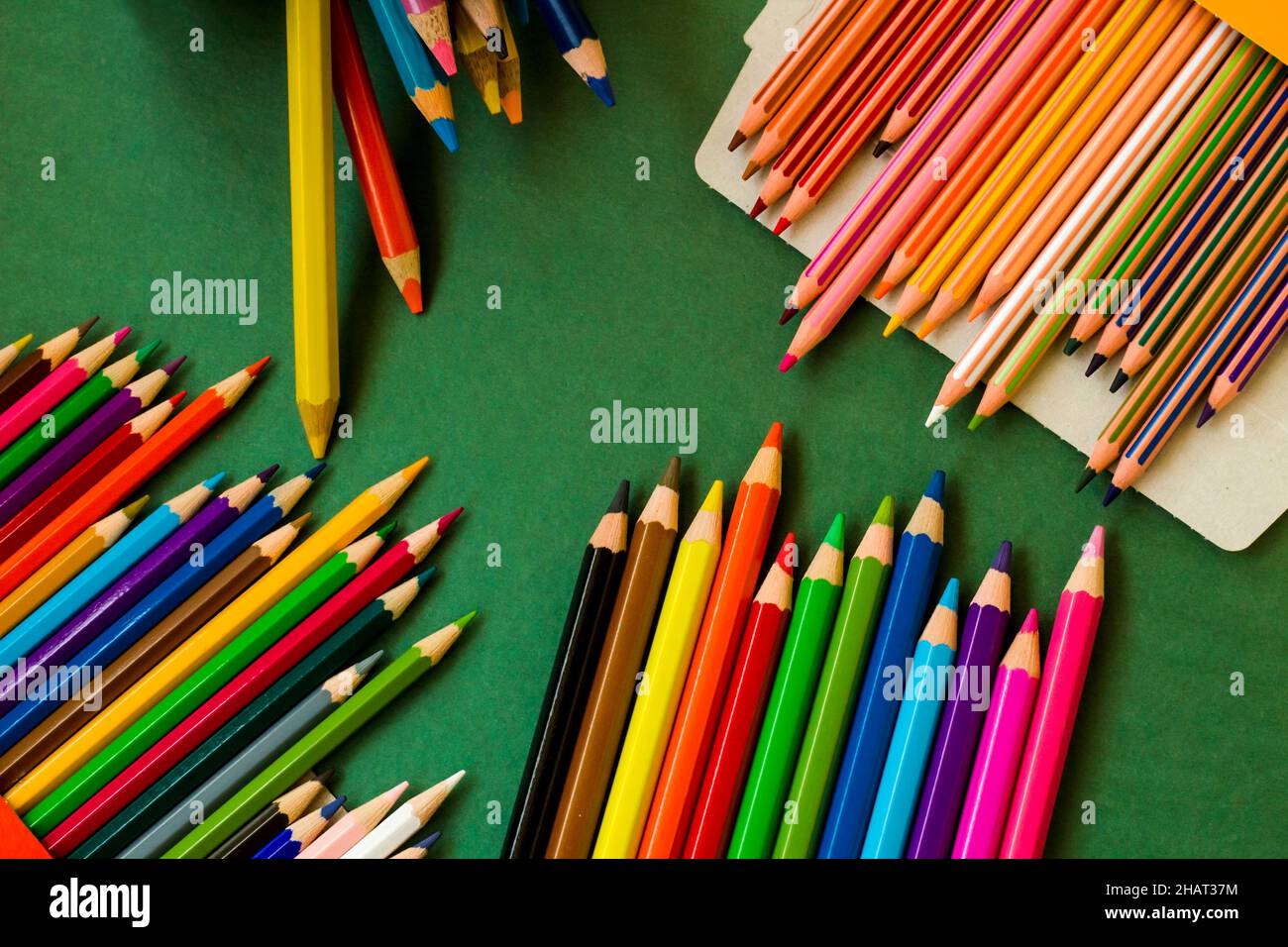 Colorful,various of color crayons designed on green surface,top view ...
