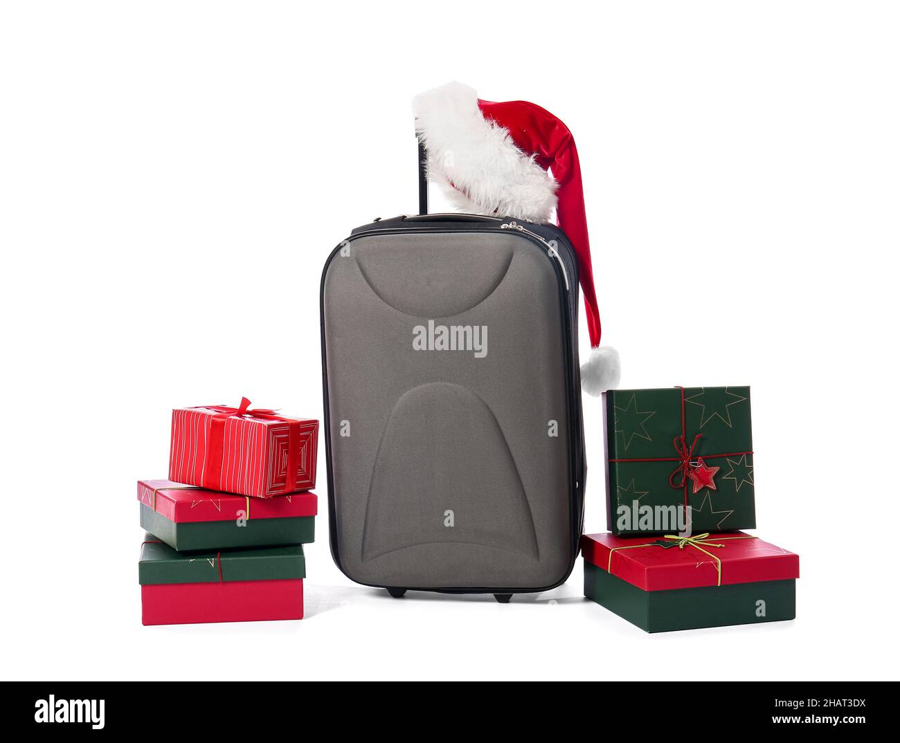 Suitcase with Santa hat and different gift boxes on white background ...