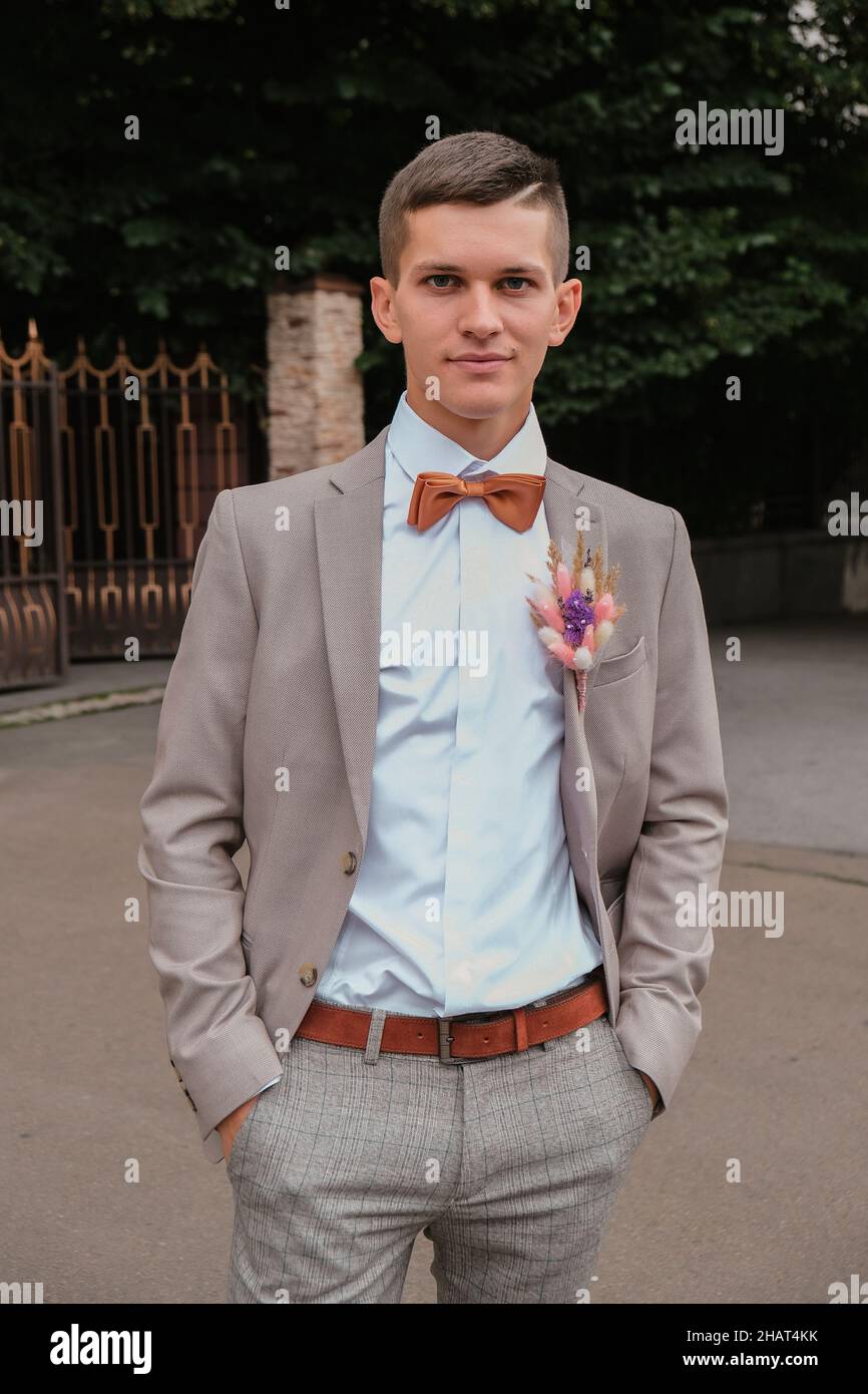 Portrait of groom in black suit, white shirt and bow tie Stock Photo ...