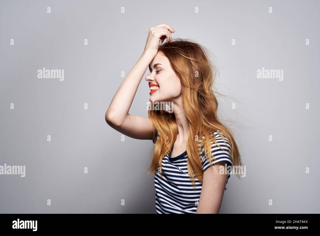 pretty woman holding hair makeup posing fun fashion model studio Stock ...