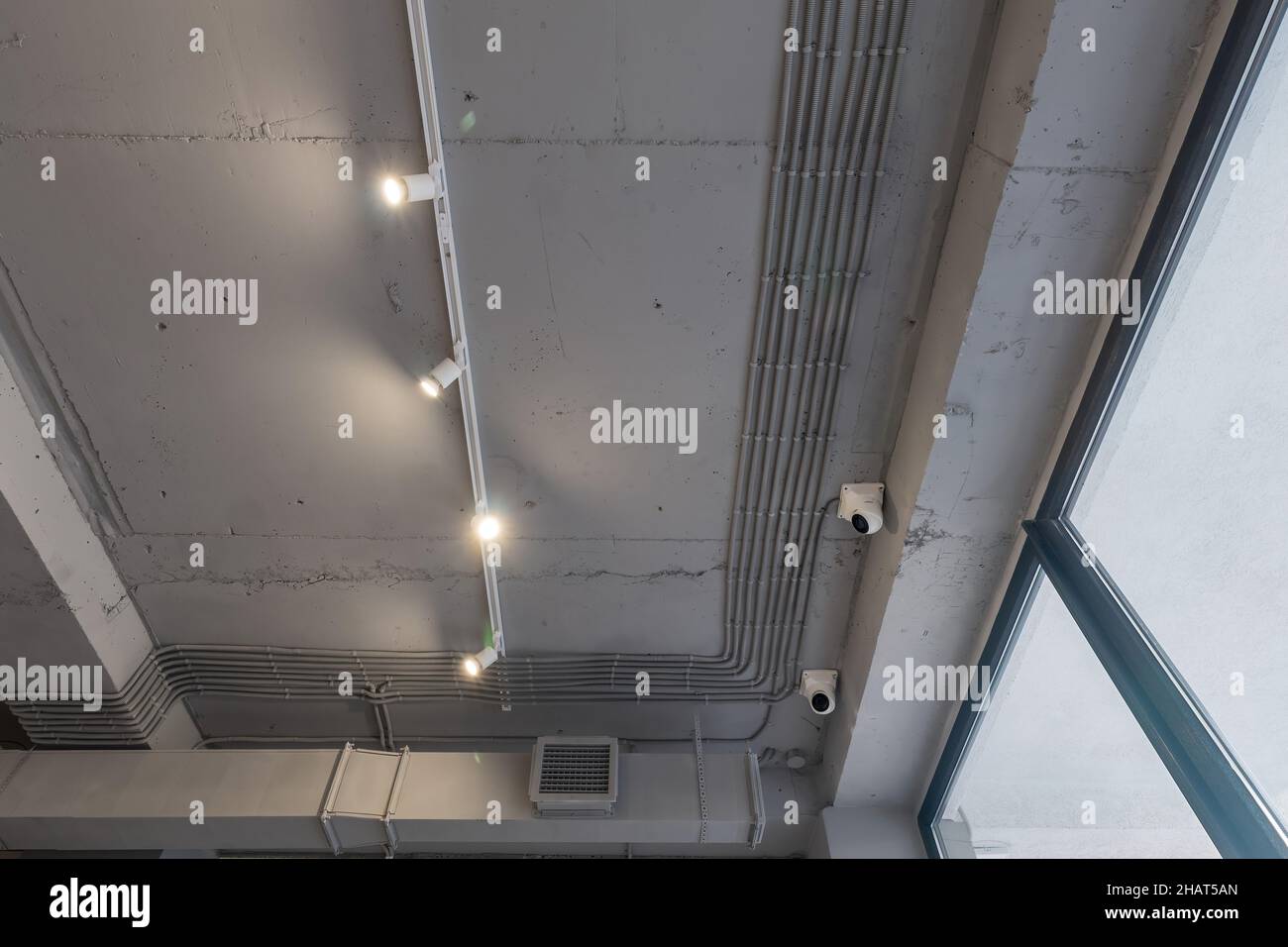 Abstract loft interior of concrete grey ceiling with air ventilation ...