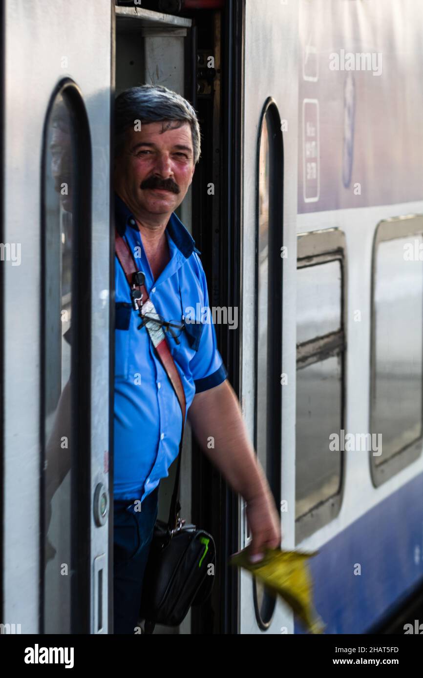 Railworker, train staff signaling for train conductor in Bucharest ...