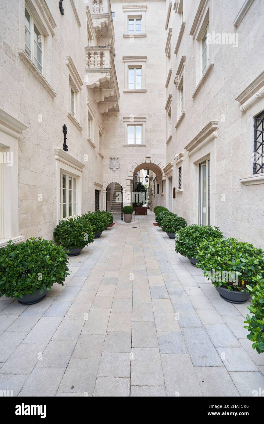 Exterior of a building made of stone and potted plants Stock Photo - Alamy
