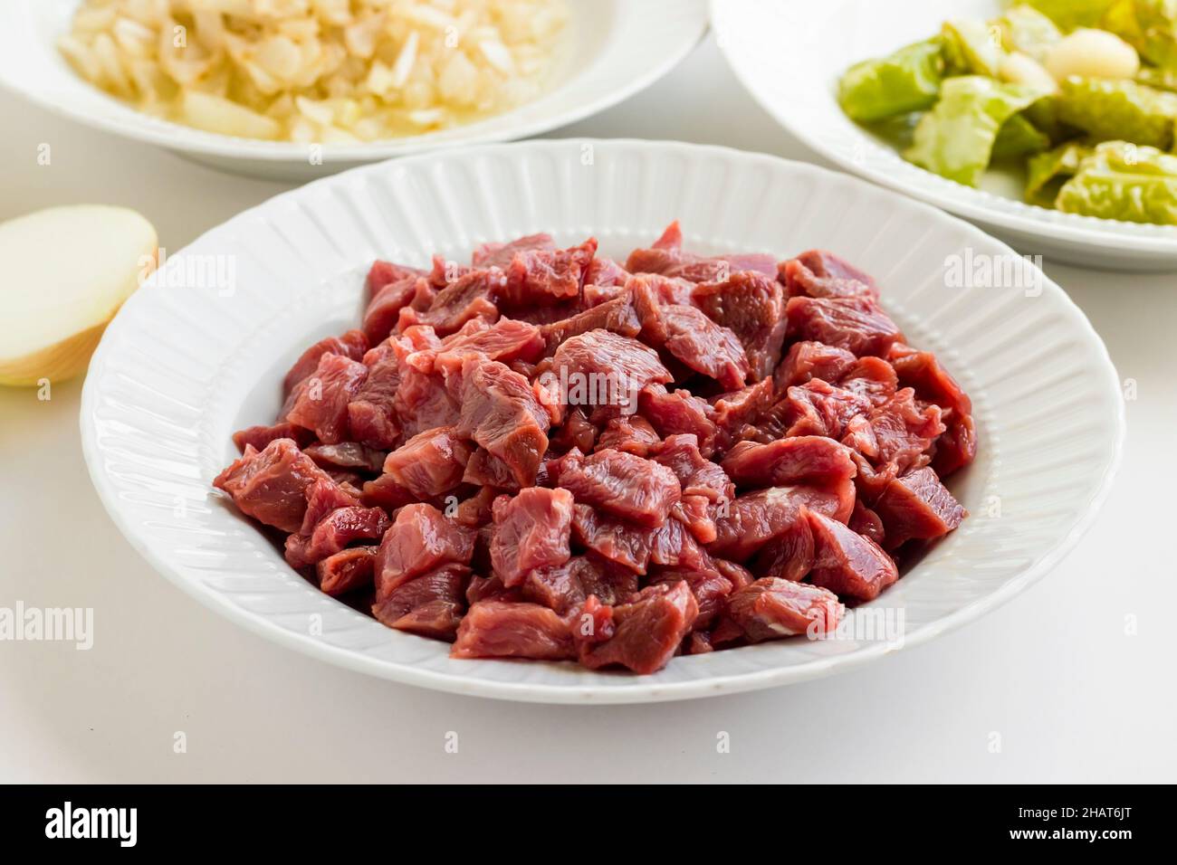 Uncooked,chopped beef meat ready for cook in plate.Festive braised meat ...