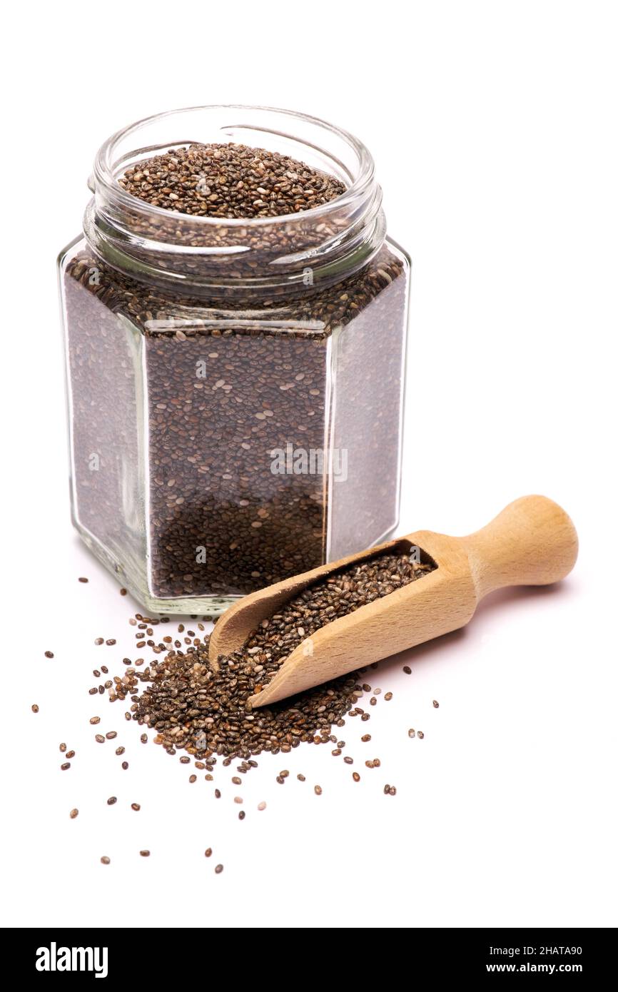 glass can full of organic natural chia seeds close-up isolated on white ...