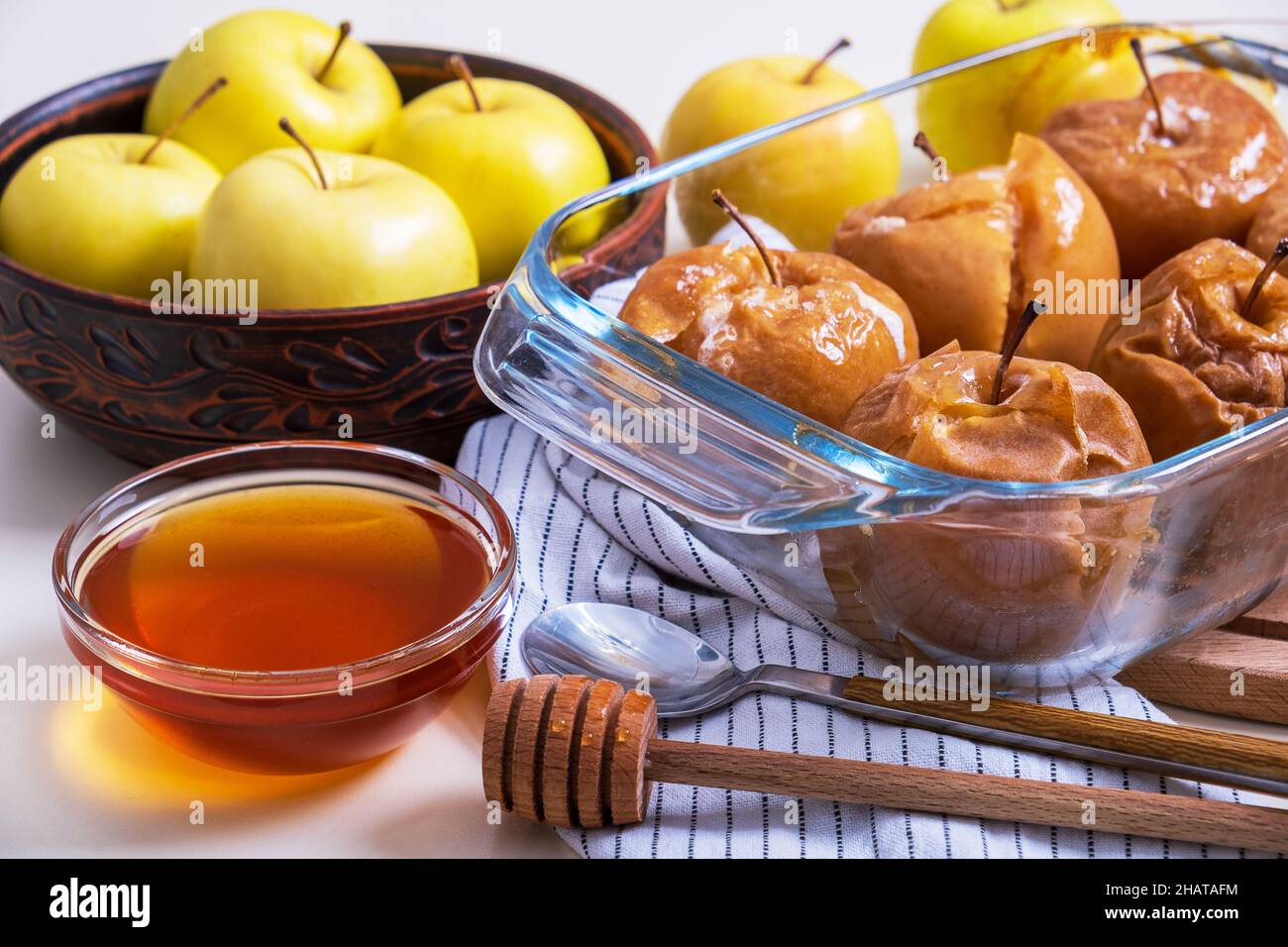 Baked caramelized apples with honey in glass refractory baking dish ...
