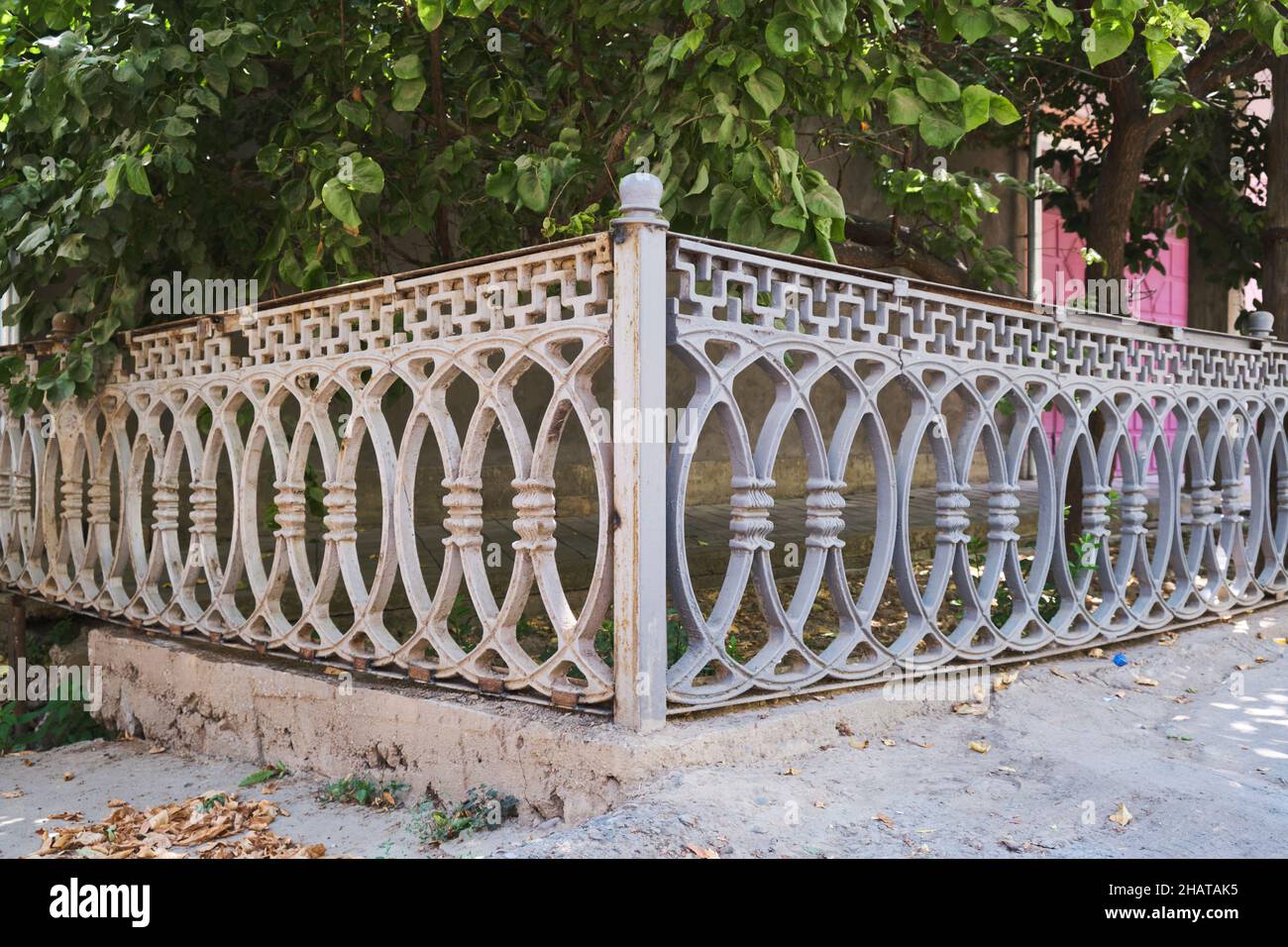 A typical old wrought iron fence in front of a house. In Tashkent ...