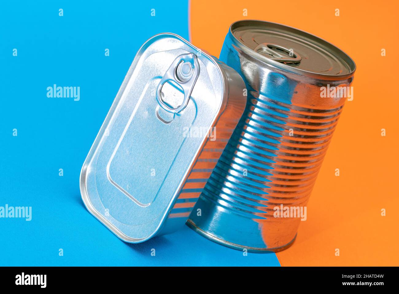A Group of Stacked Tin Cans with Blank Edges on Split Blue and Orange ...