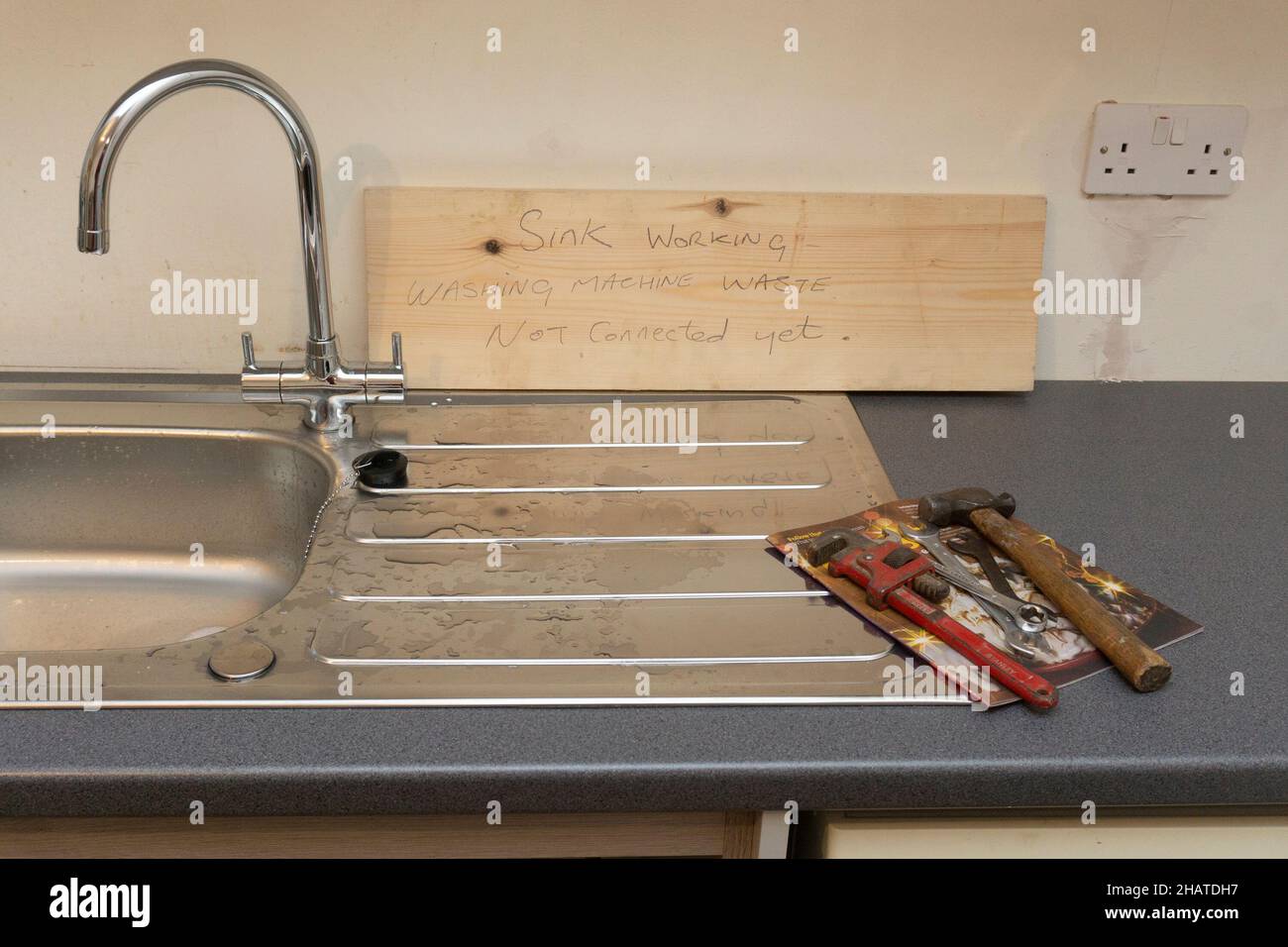 Kitchen sink installation incomplete hand written builder sign water ...