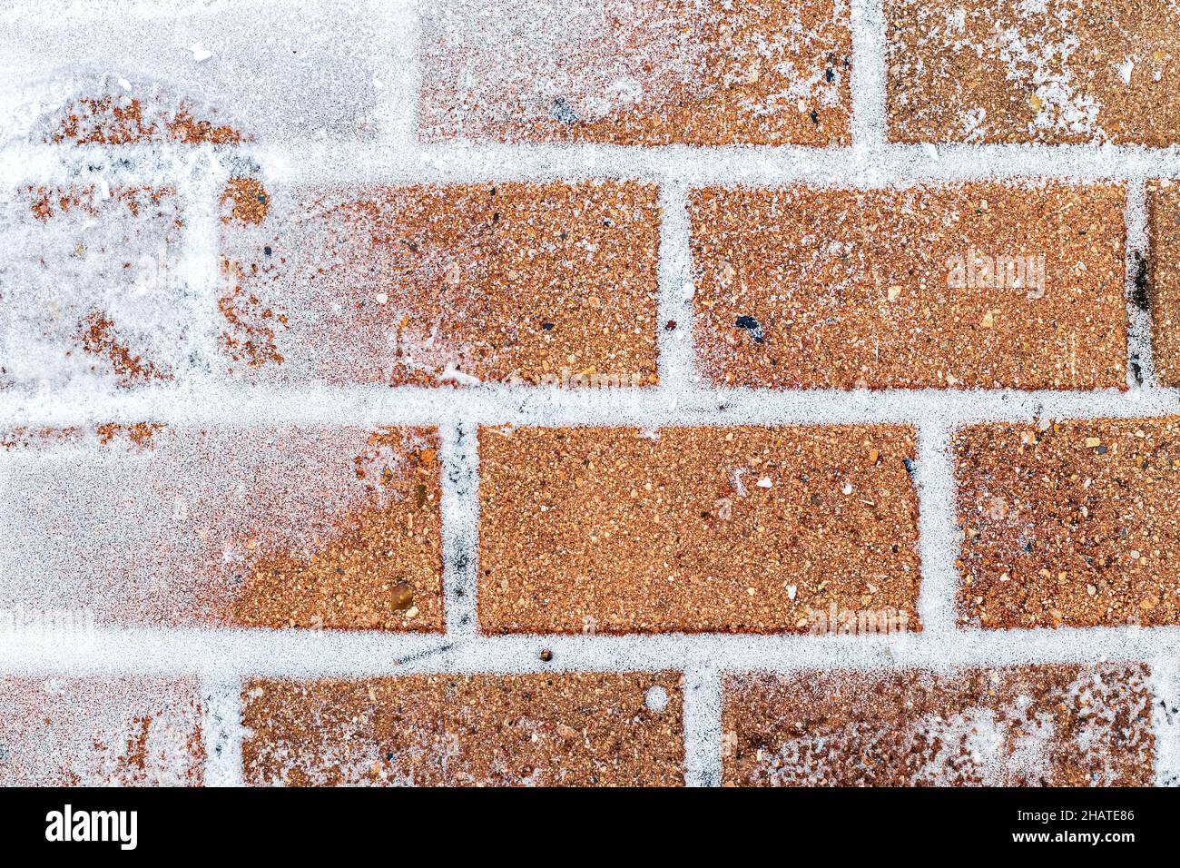 The texture of the cobblestone path covered with the first snow in ...