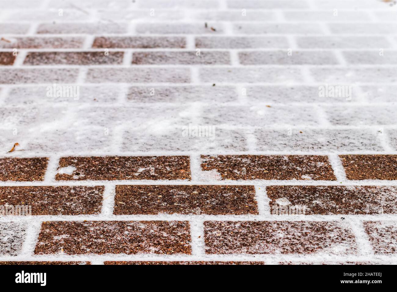 The texture of the cobblestone path covered with the first snow in ...