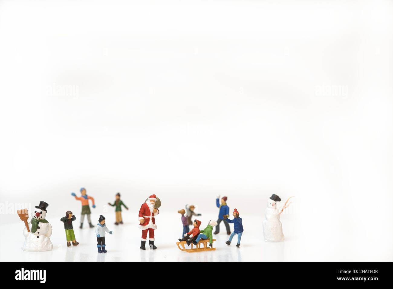 Christmas scene of miniature figures of kids and Santa Claus playing in ...