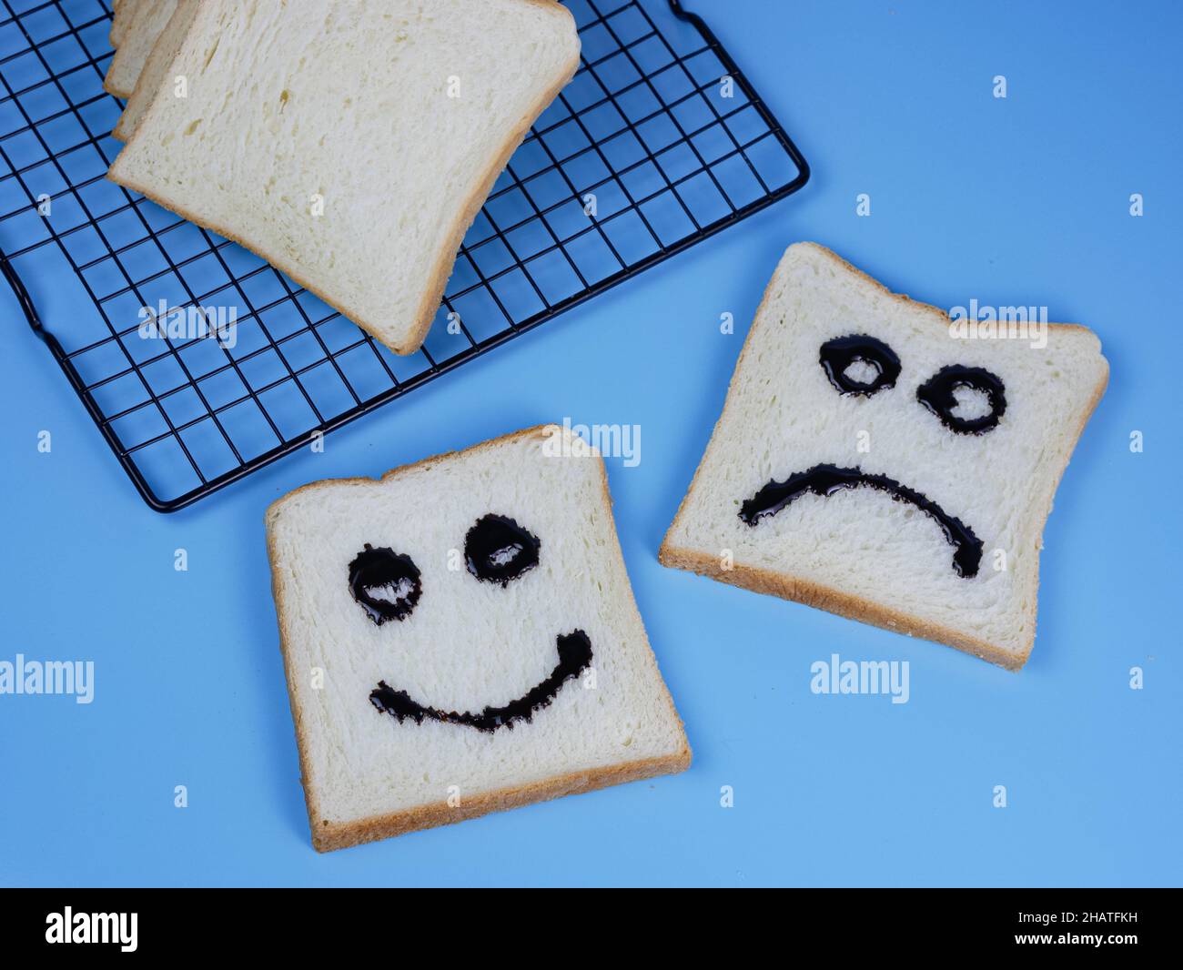 toasted bread with smiley and sad emoticons, for the concept of ...