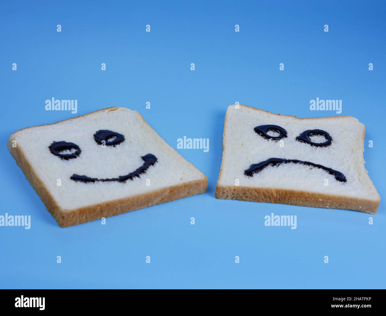 toasted bread with smiley and sad emoticons, for the concept of happiness and sadness Stock ...