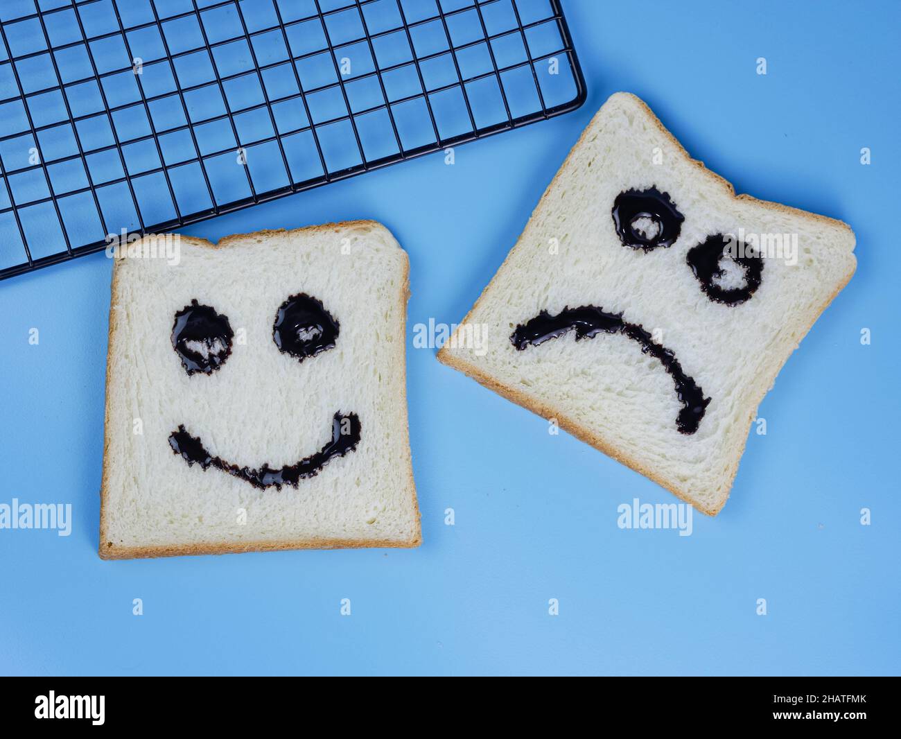 toasted bread with smiley and sad emoticons, for the concept of ...