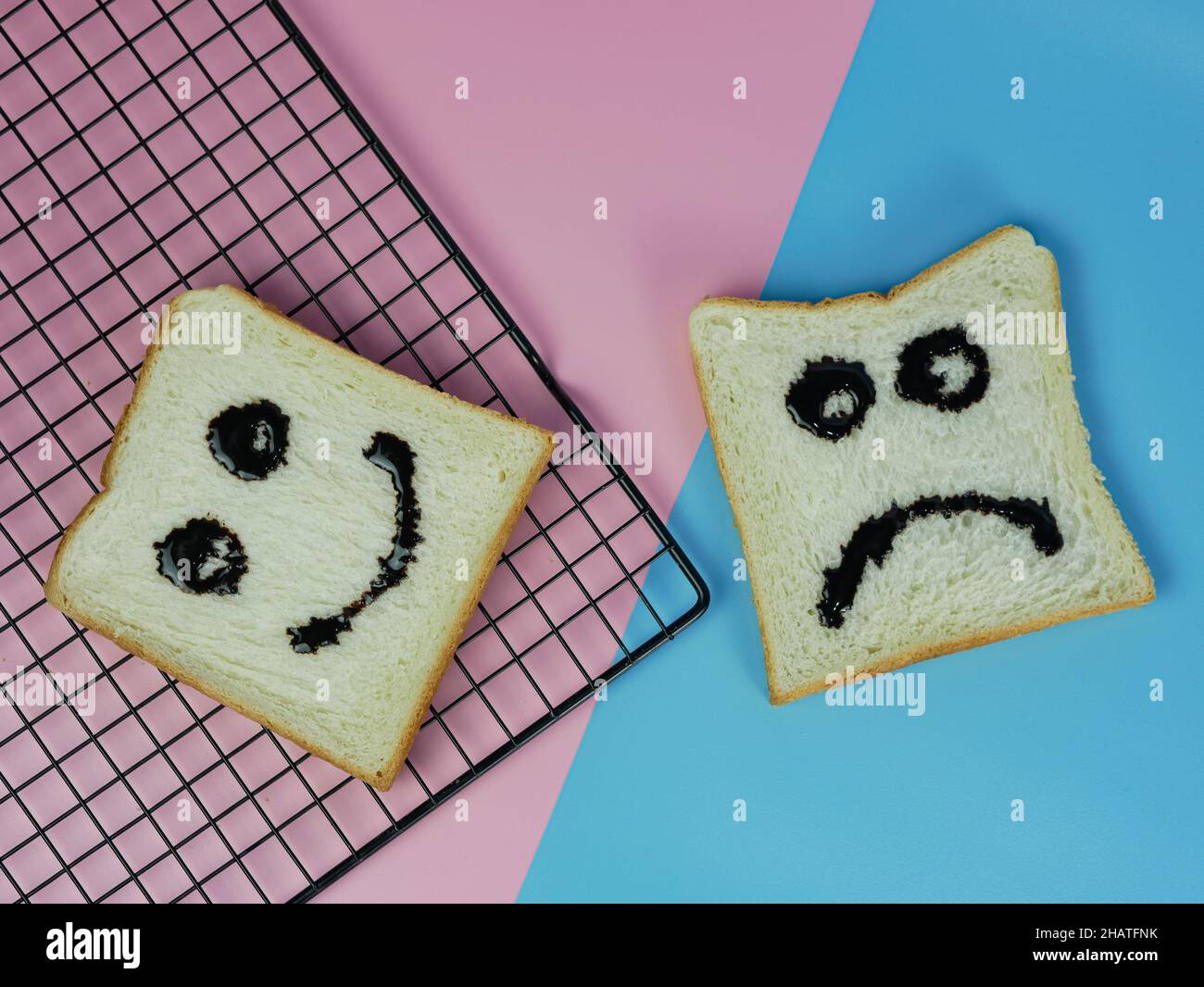toasted bread with smiley and sad emoticons, for the concept of happiness and sadness Stock ...