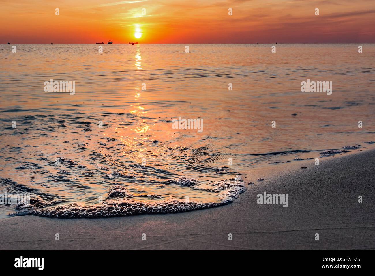 Glorious scenery of a golden sunset on the sandy beach Stock Photo - Alamy