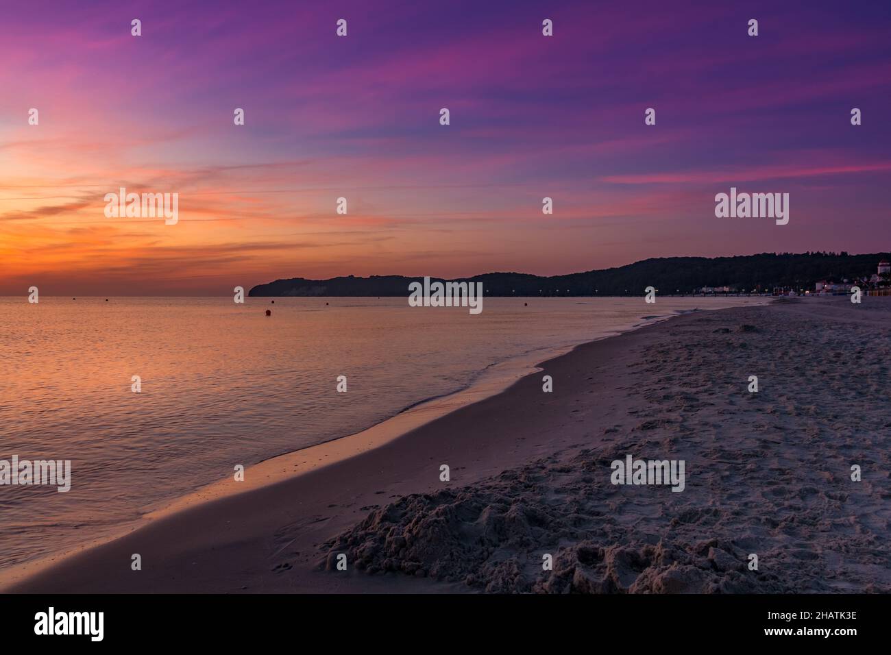 Glorious scenery of a purple sunset on the sandy beach Stock Photo - Alamy