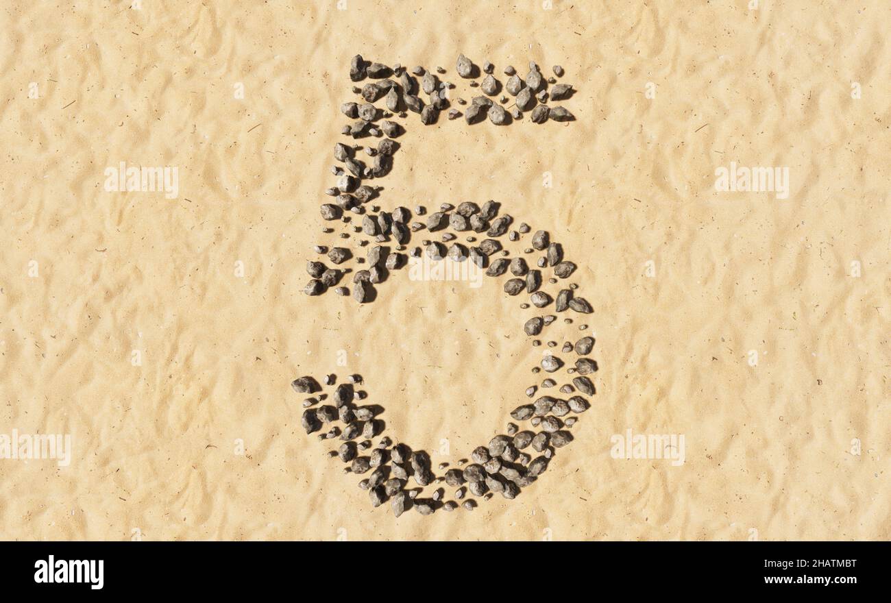 Concept or conceptual stones on beach sand handmade symbol shape ...