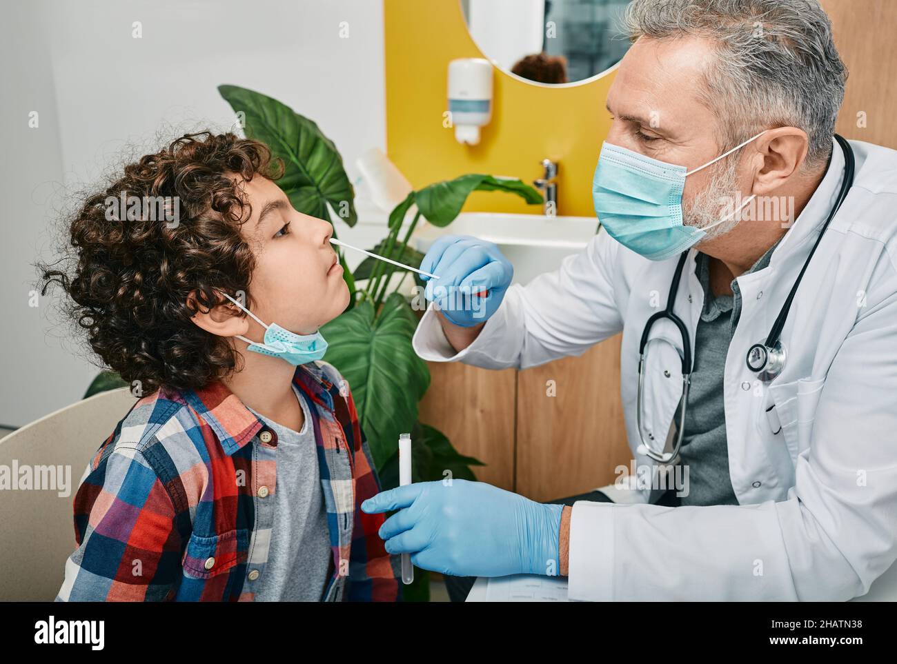 Curly boy during PCR test of COVID-19 in a medical laboratory ...