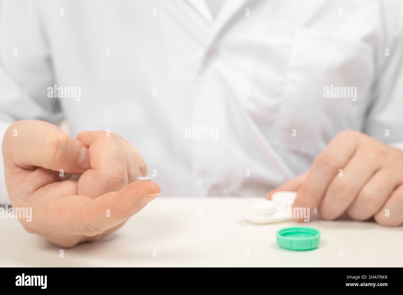Contact lenses. Holding contact lens on finger tip. Man hand holding ...