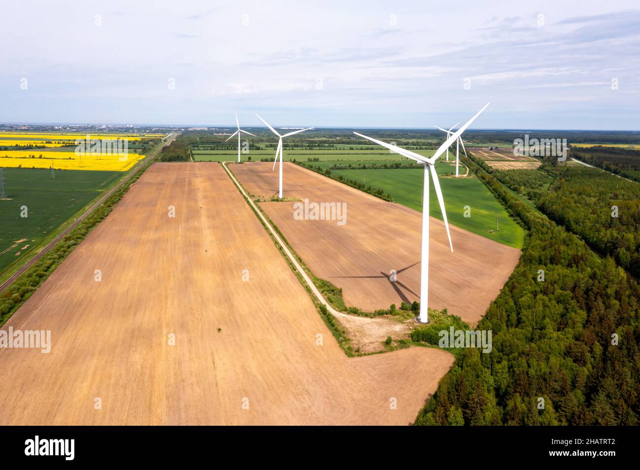 aerial view of a large three blade industrial wind turbine generating ...